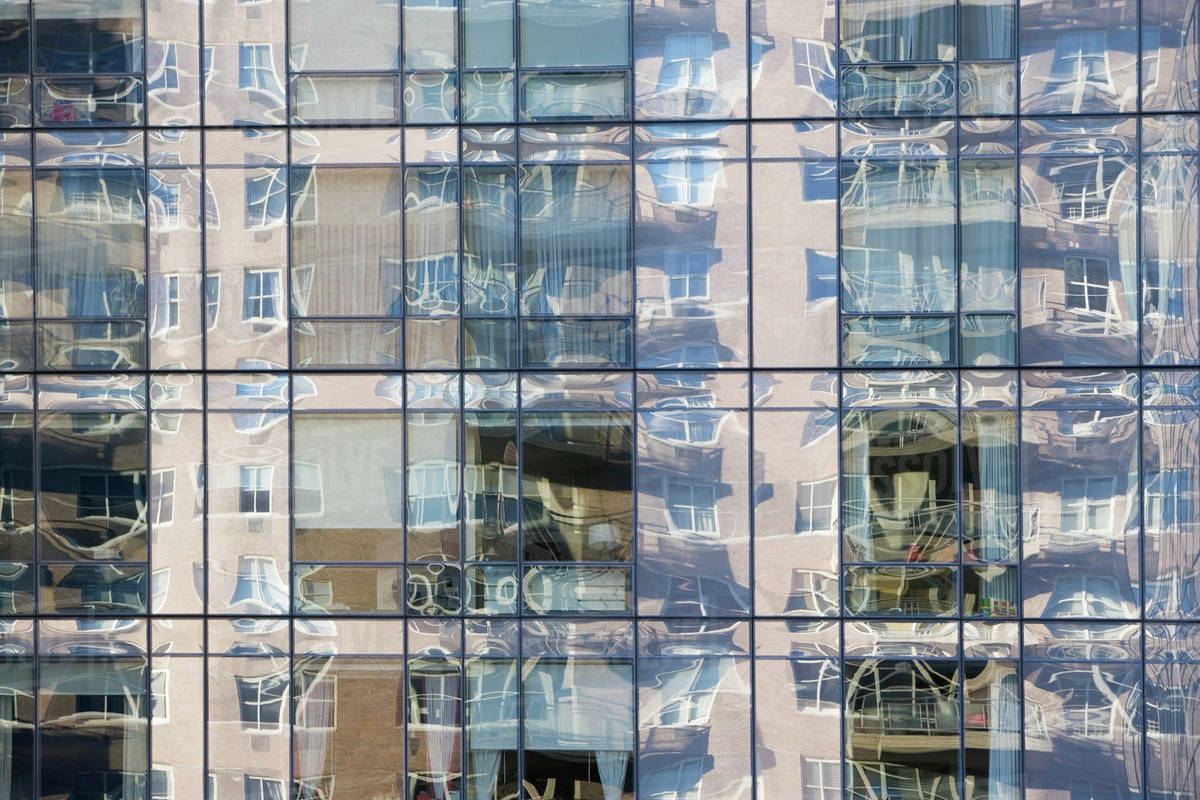 Reflection on glass skyscraper - Stock Photo - Dissolve