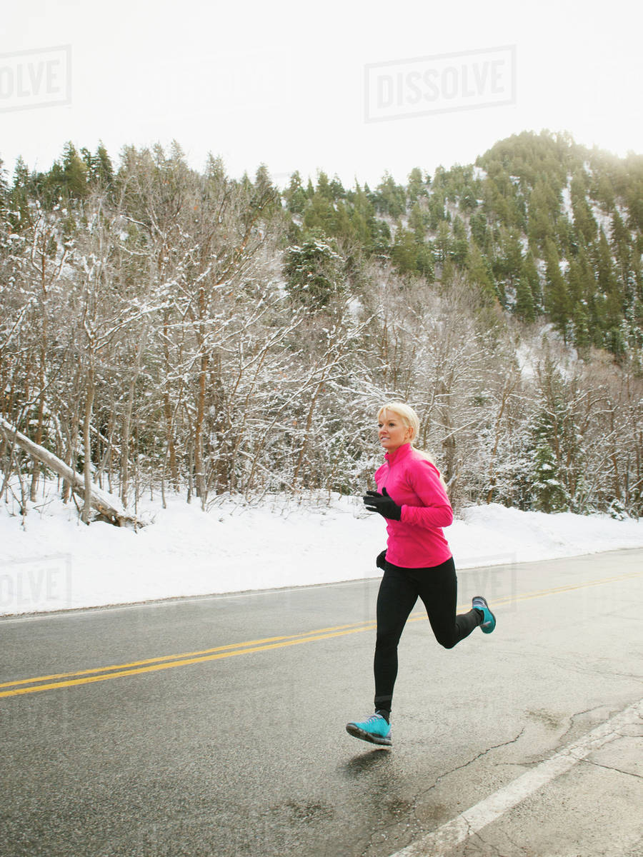 Woman jogging in winter - Royalty-free Stock Photo | Dissolve