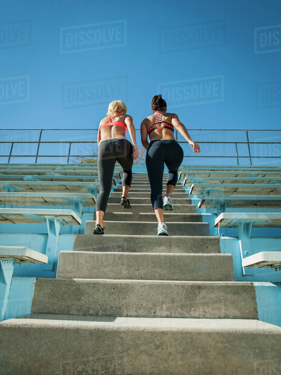 Two women walking up steps - Royalty-free Stock Photo | Dissolve