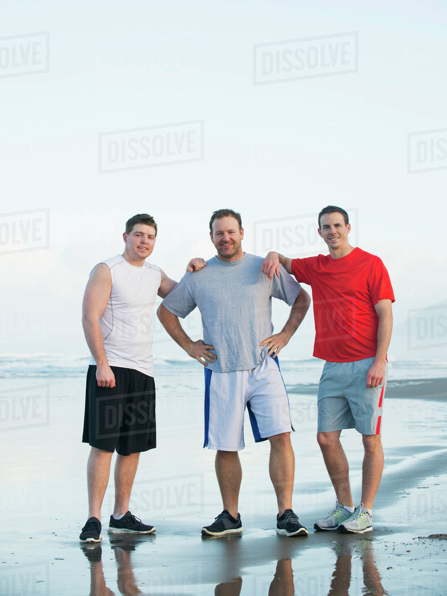 Portrait of men on beach - Royalty-free Stock Photo | Dissolve