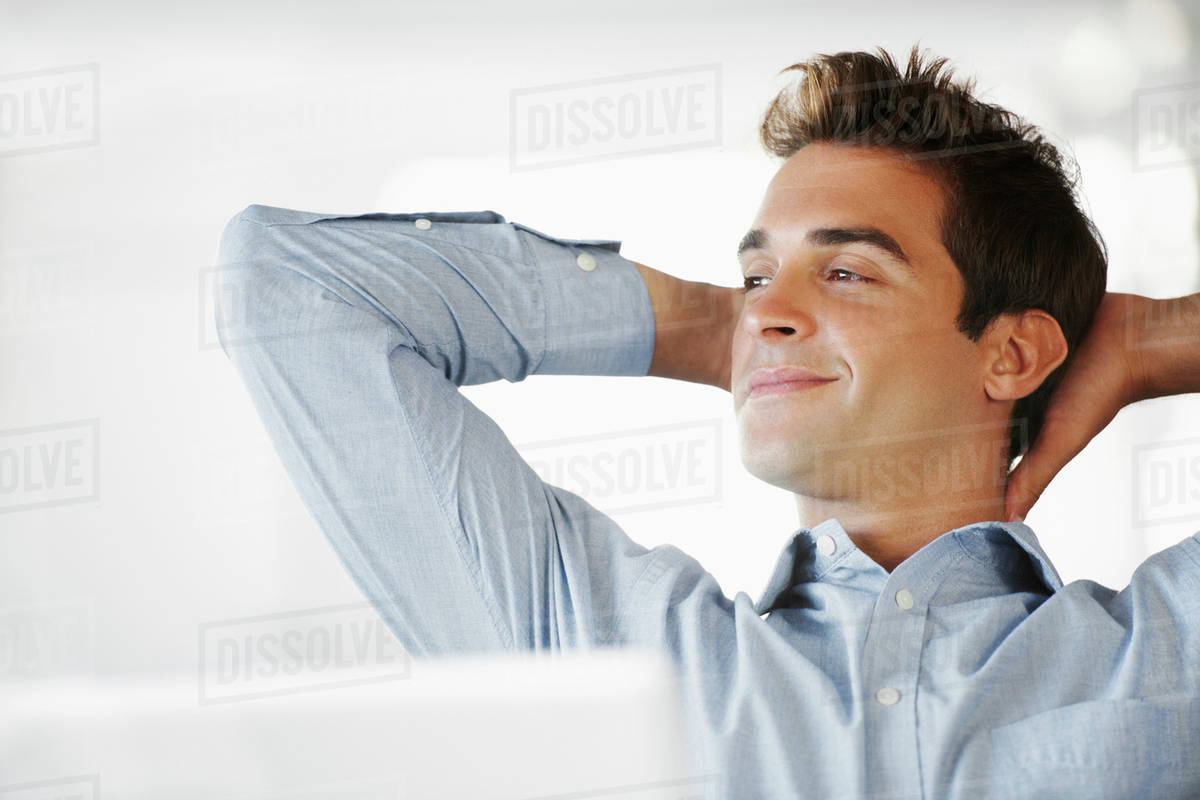 Portrait of man with hands behind head - Royalty-free Stock Photo ...