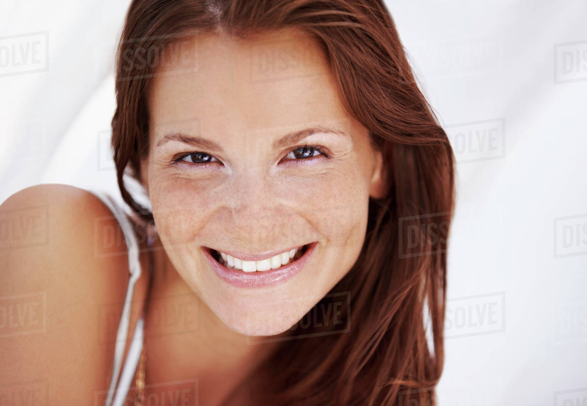 Studio portrait of woman smiling - Stock Photo - Dissolve