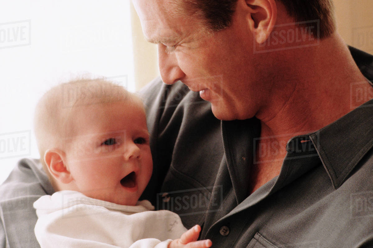 Father smiling at his baby - Royalty-free Stock Photo | Dissolve