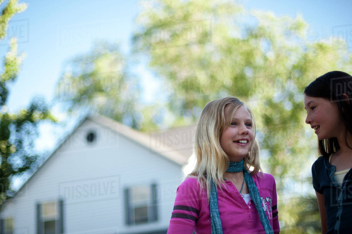Two young girls talking outside - Royalty-free Stock Photo | Dissolve