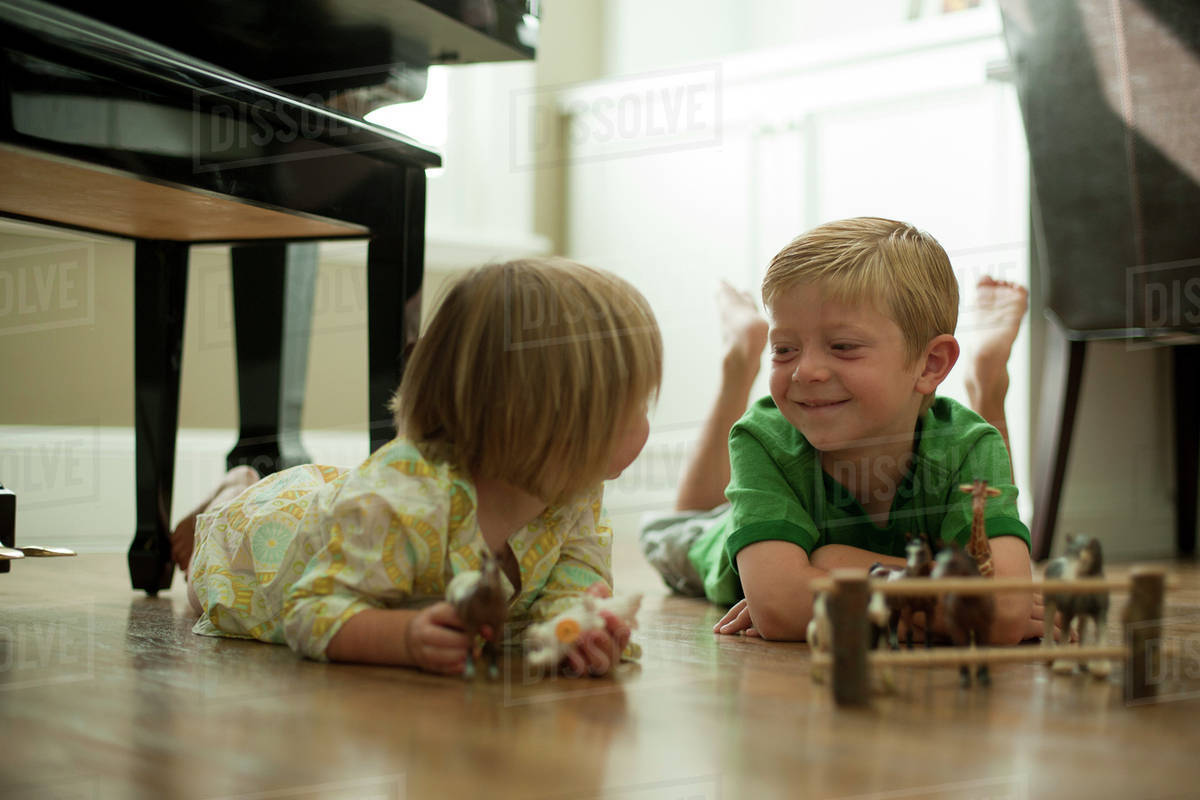 Brother and sister playing with toy animals - Royalty-free Stock Photo ...