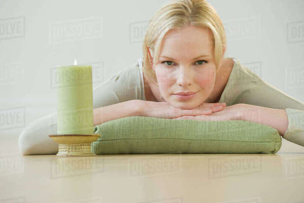 Woman relaxing with candle - Stock Photo - Dissolve