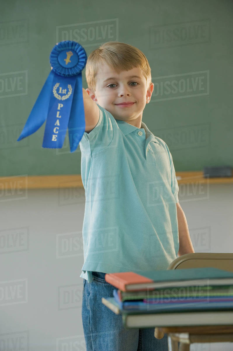 Boy holding first place ribbon - Royalty-free Stock Photo | Dissolve
