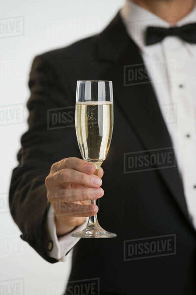 Man in tuxedo toasting with champagne - Royalty-free Stock Photo | Dissolve