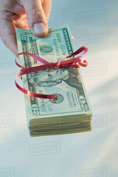 Man holding stack of money wrapped in ribbon - Royalty-free Stock Photo ...