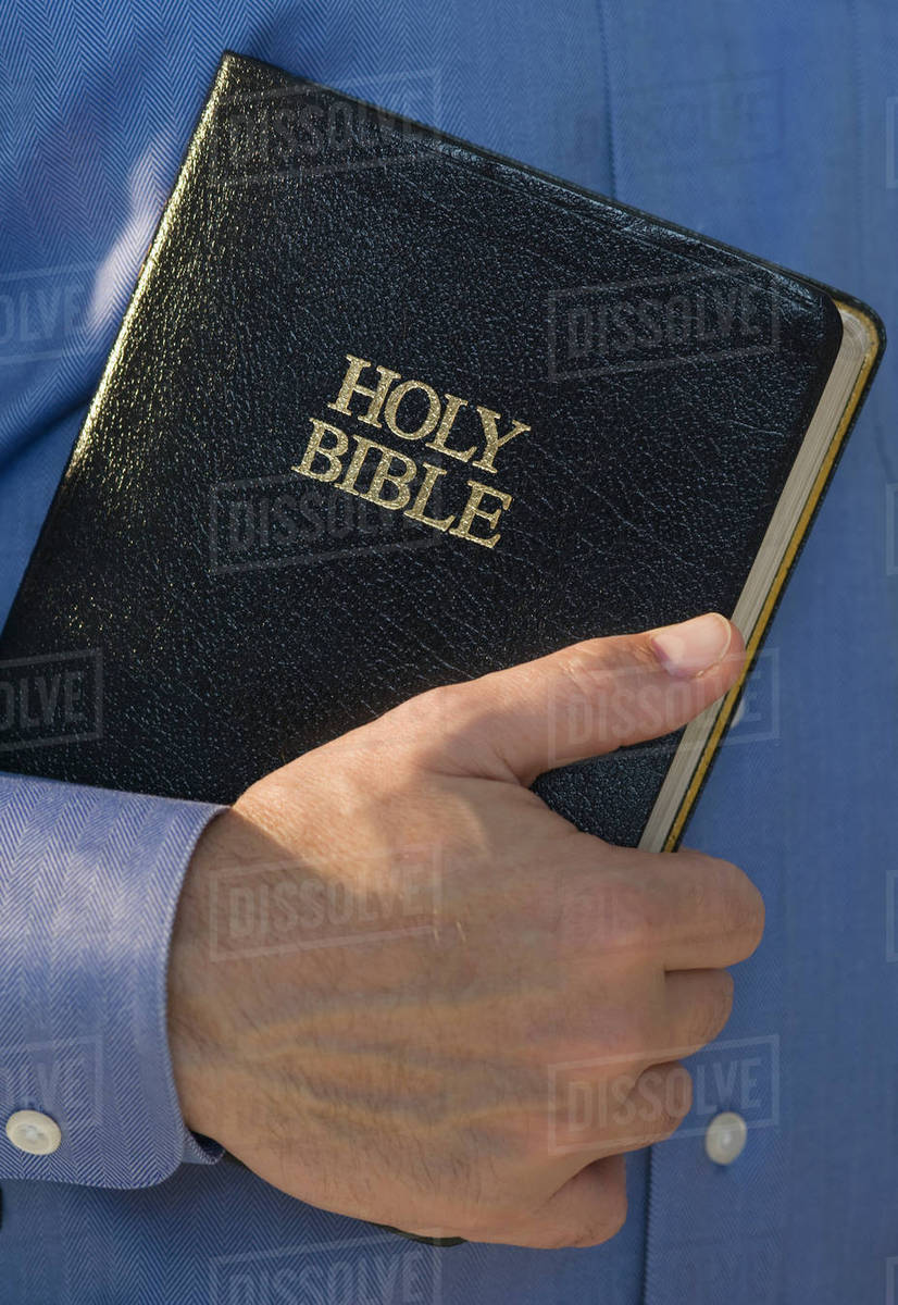 Man holding Holy Bible - Royalty-free Stock Photo | Dissolve
