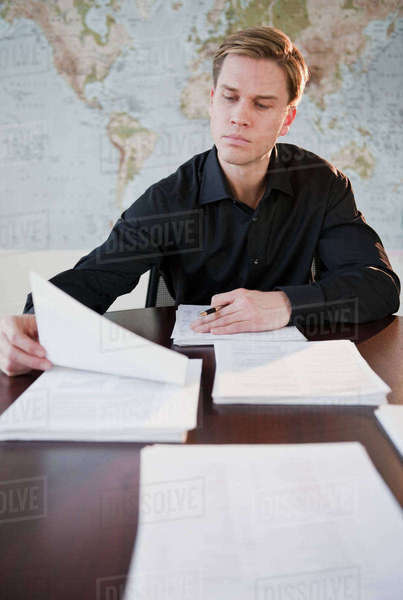 Businessman reviewing documents - Royalty-free Stock Photo | Dissolve