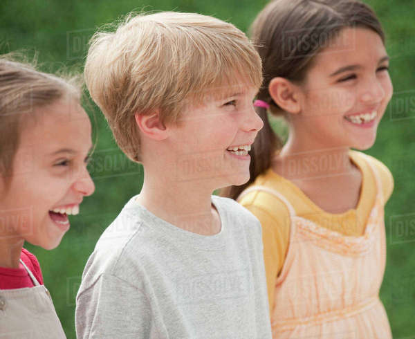 Three children outdoors - Royalty-free Stock Photo | Dissolve