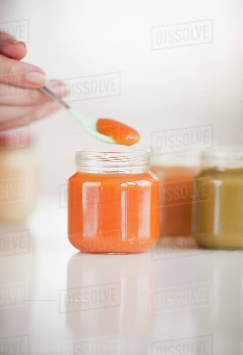 Hand spooning baby food - Royalty-free Stock Photo | Dissolve