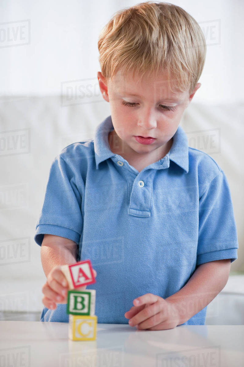 Child playing with ABC blocks - Royalty-free Stock Photo | Dissolve