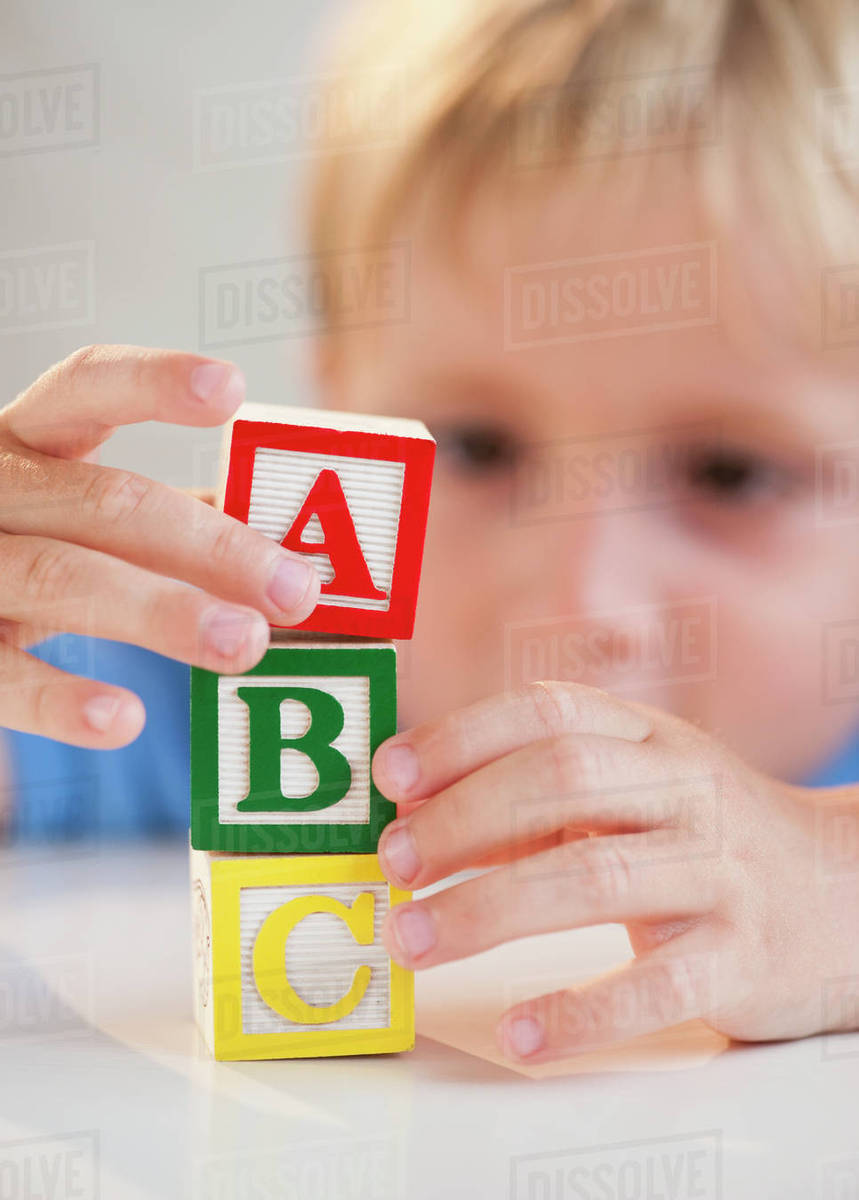 Child playing with ABC blocks - Royalty-free Stock Photo | Dissolve