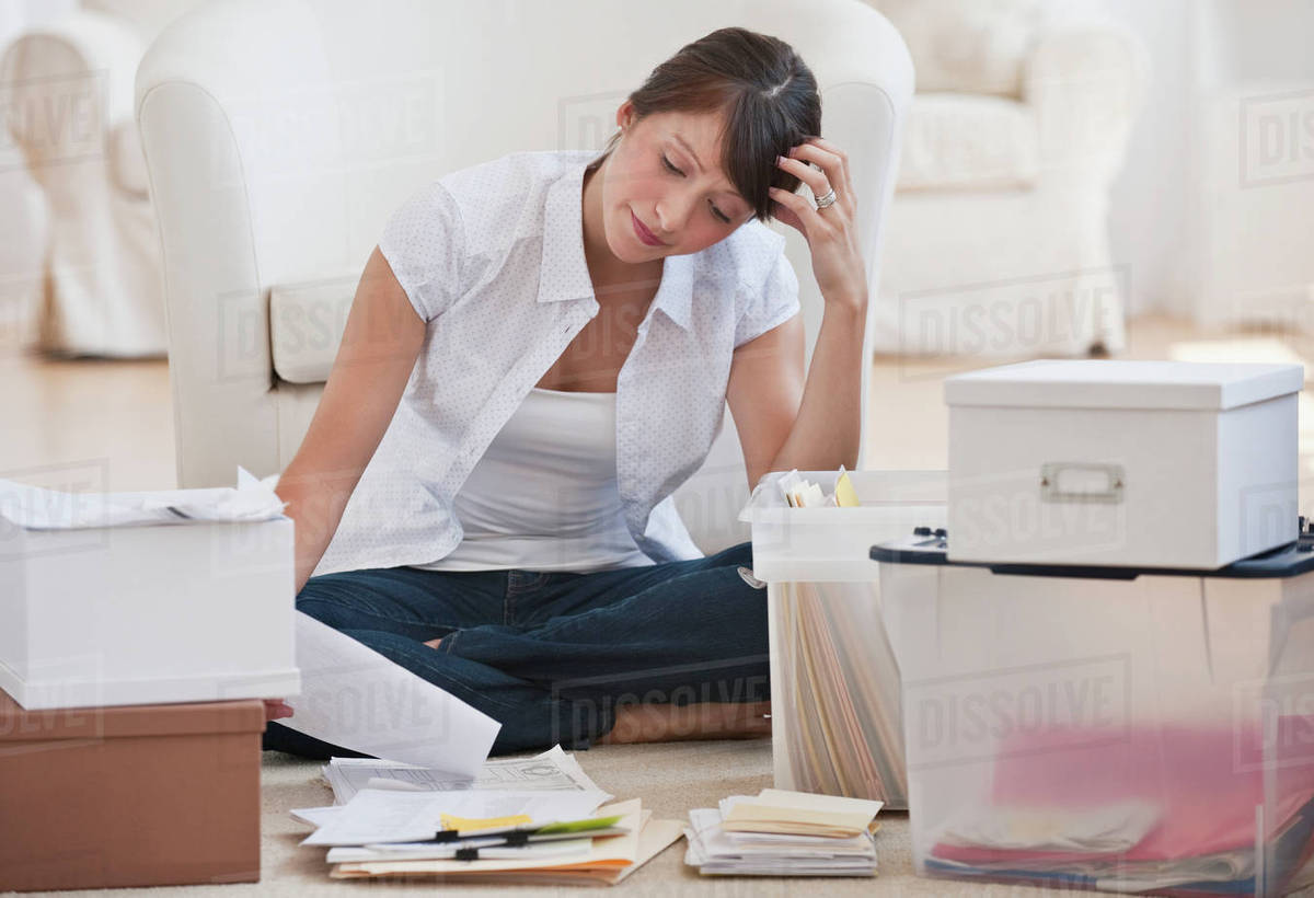 Woman organizing papers - Stock Photo - Dissolve