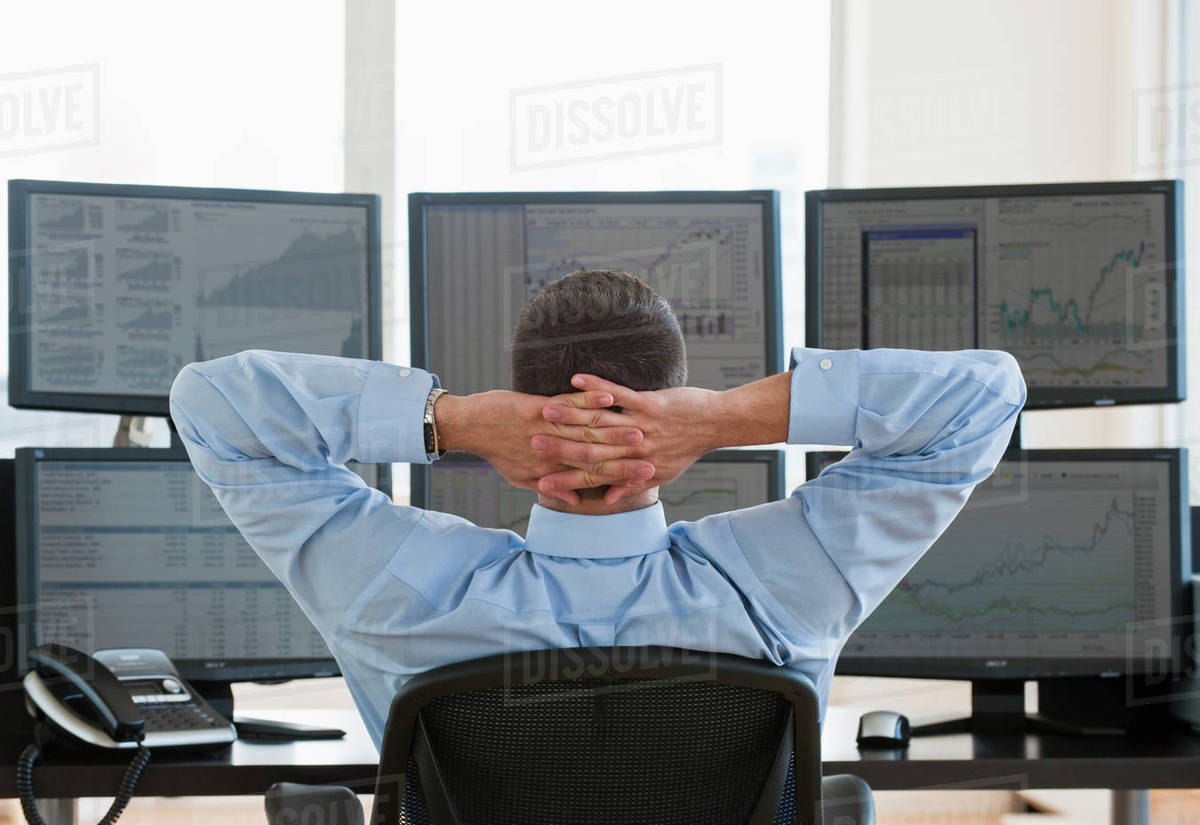Relaxed male trader at work - Royalty-free Stock Photo | Dissolve