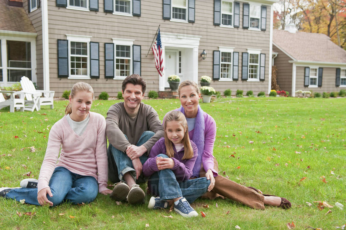 Family in front of house - Stock Photo - Dissolve