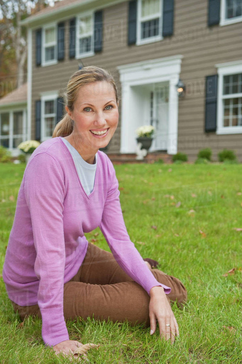 Woman in front of house - Royalty-free Stock Photo | Dissolve
