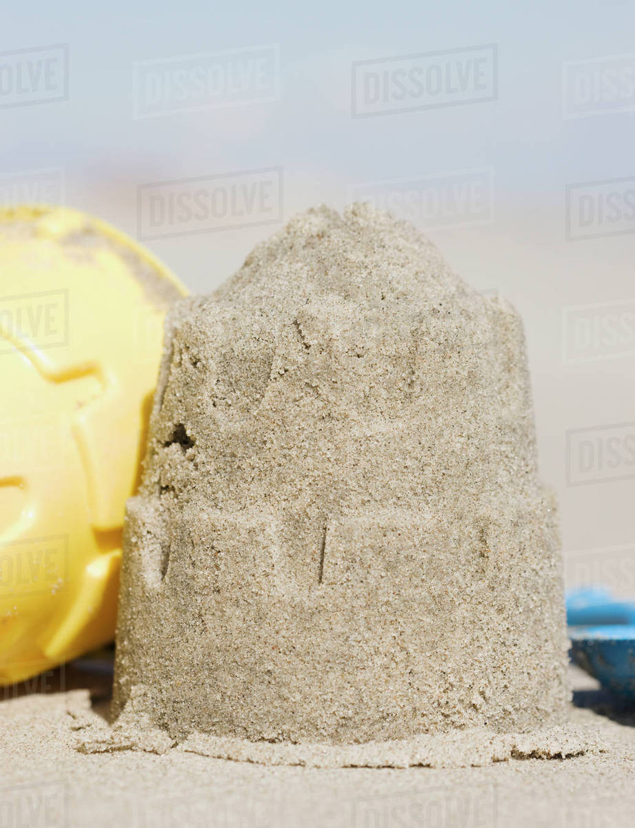 Sand castle mold on beach - Stock Photo - Dissolve