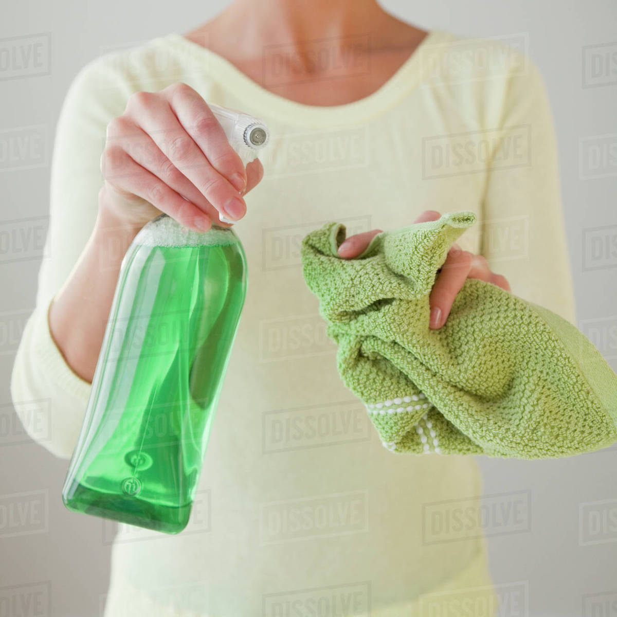 Woman holding green cleaning products - Stock Photo - Dissolve
