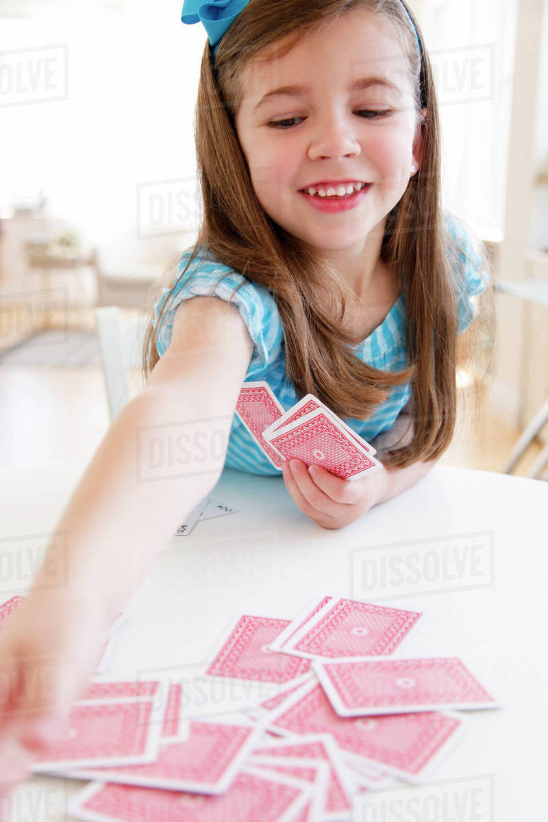 Child playing cards - Stock Photo - Dissolve