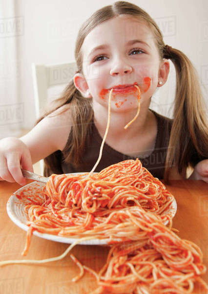 Child eating spaghetti - Stock Photo - Dissolve