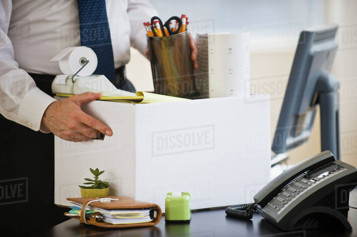 A businessman packing up desk - Royalty-free Stock Photo | Dissolve
