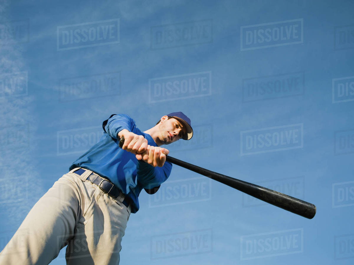 Baseball player swinging bat - Stock Photo - Dissolve