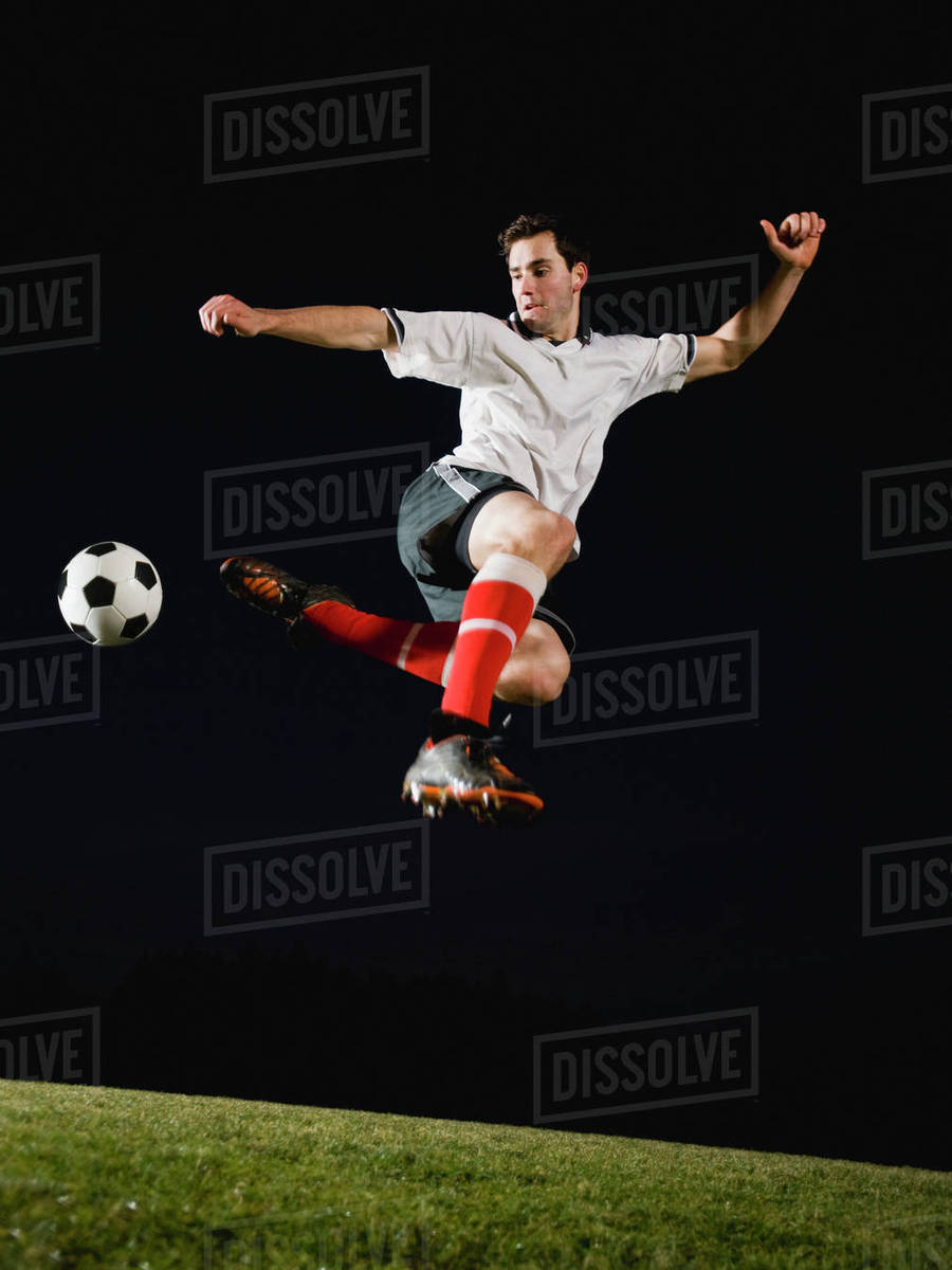 Soccer player kicking ball - Royalty-free Stock Photo | Dissolve