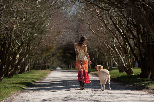 Woman walking dog - Stock Photo - Dissolve