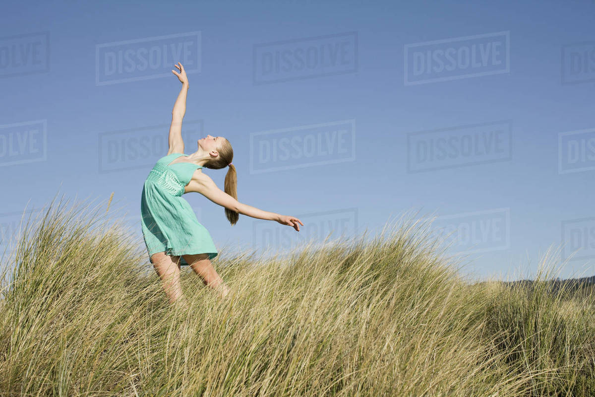 Woman dancing on sand dunes - Royalty-free Stock Photo | Dissolve
