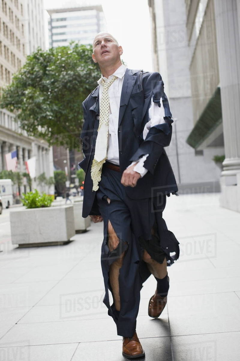 Businessman wearing torn clothing, walking in street, San Francisco ...