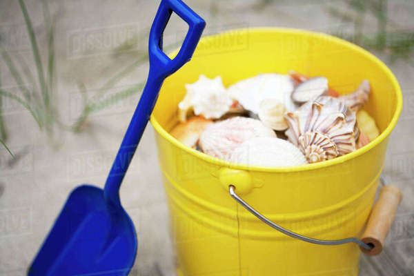 Beach shovel and pail of shells - Royalty-free Stock Photo | Dissolve