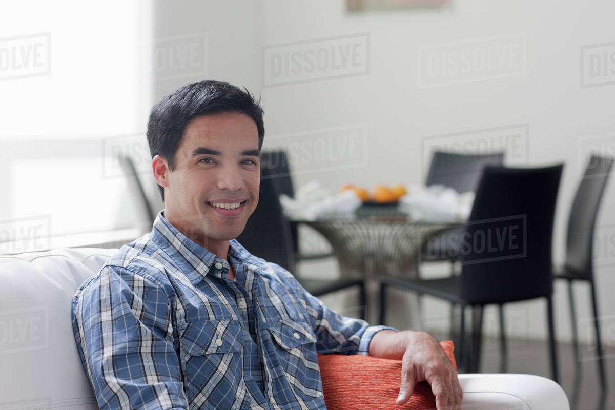 Portrait of man sitting in living room - Royalty-free Stock Photo ...