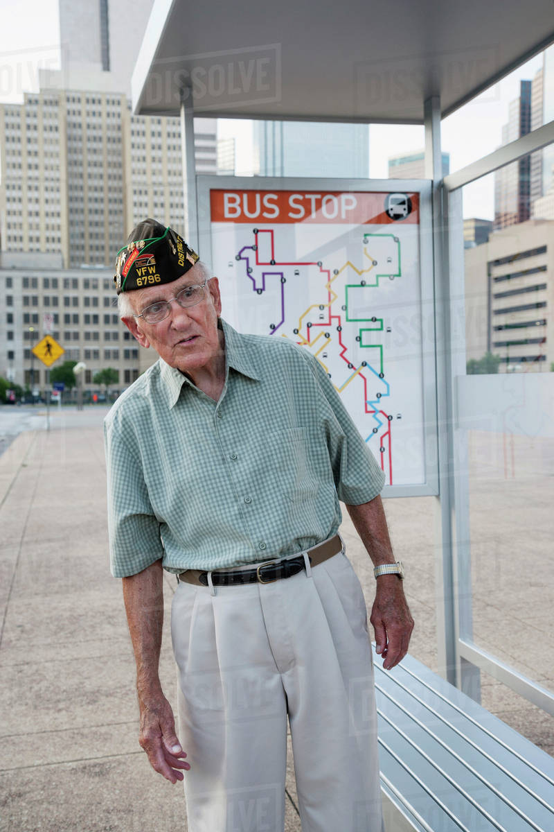 Senior man standing at bus stop - Royalty-free Stock Photo | Dissolve