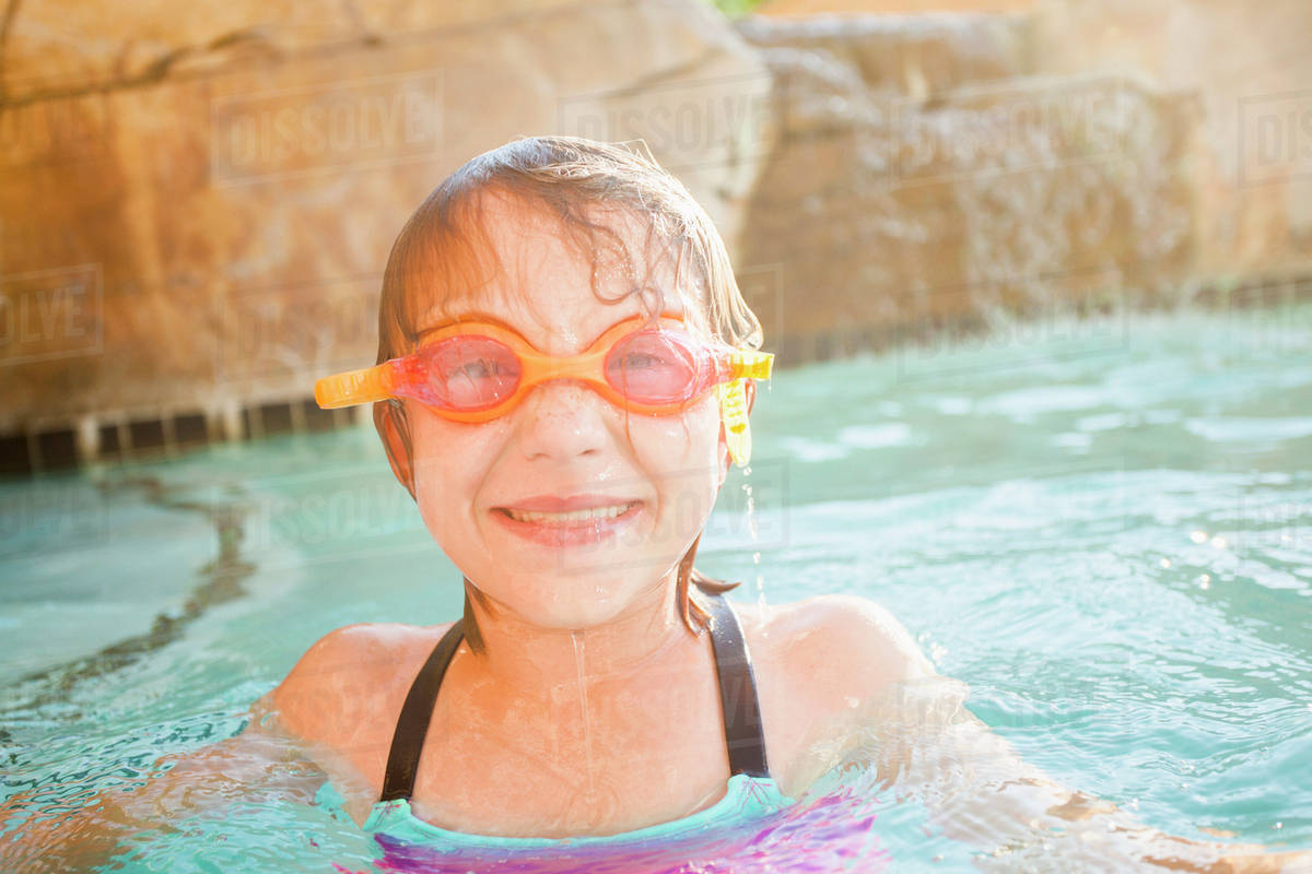 Girl (8-9) playing in swimming pool - Royalty-free Stock Photo | Dissolve