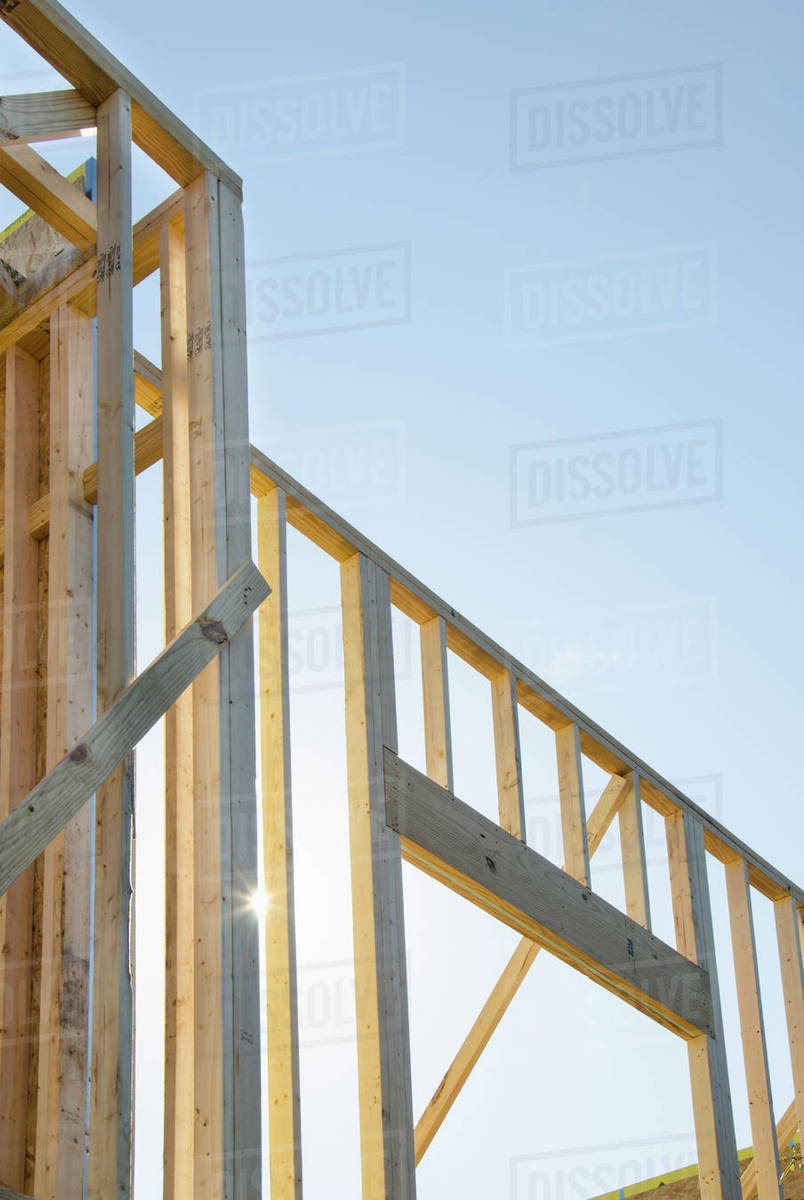 Wooden construction frames against clear sky - Stock Photo - Dissolve