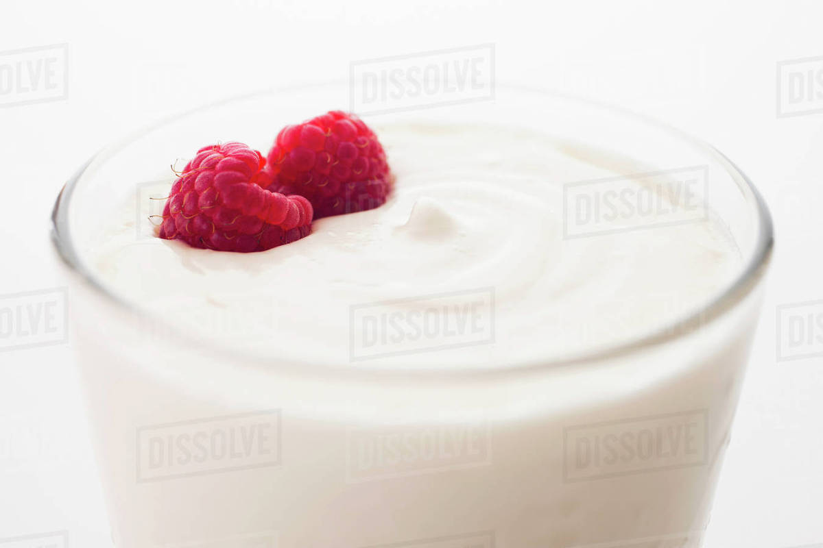 Yogurt with raspberries in drinking glass - Royalty-free Stock Photo ...