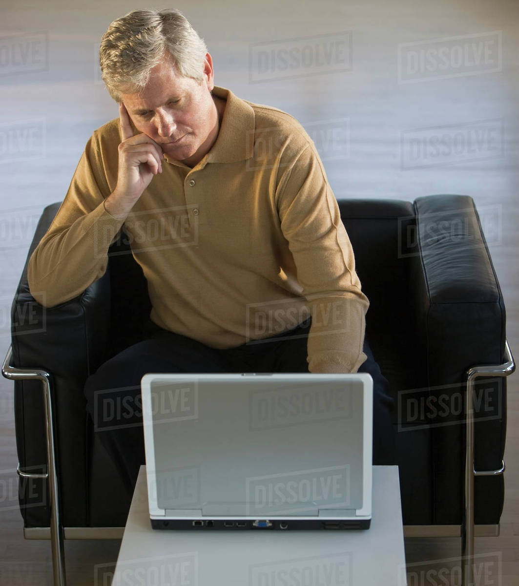 Man looking at laptop - Royalty-free Stock Photo | Dissolve