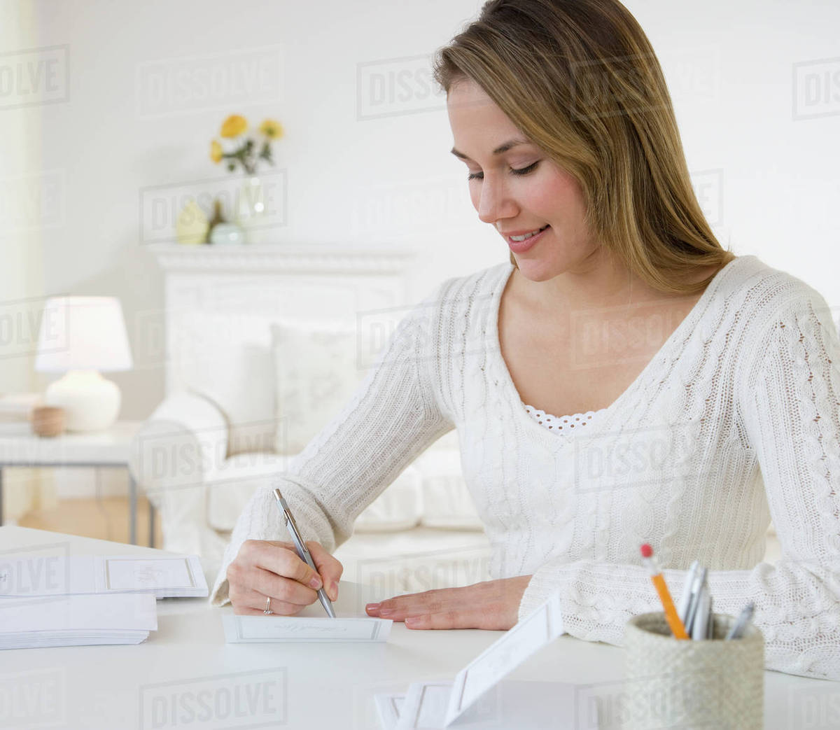 Woman writing at desk - Royalty-free Stock Photo | Dissolve