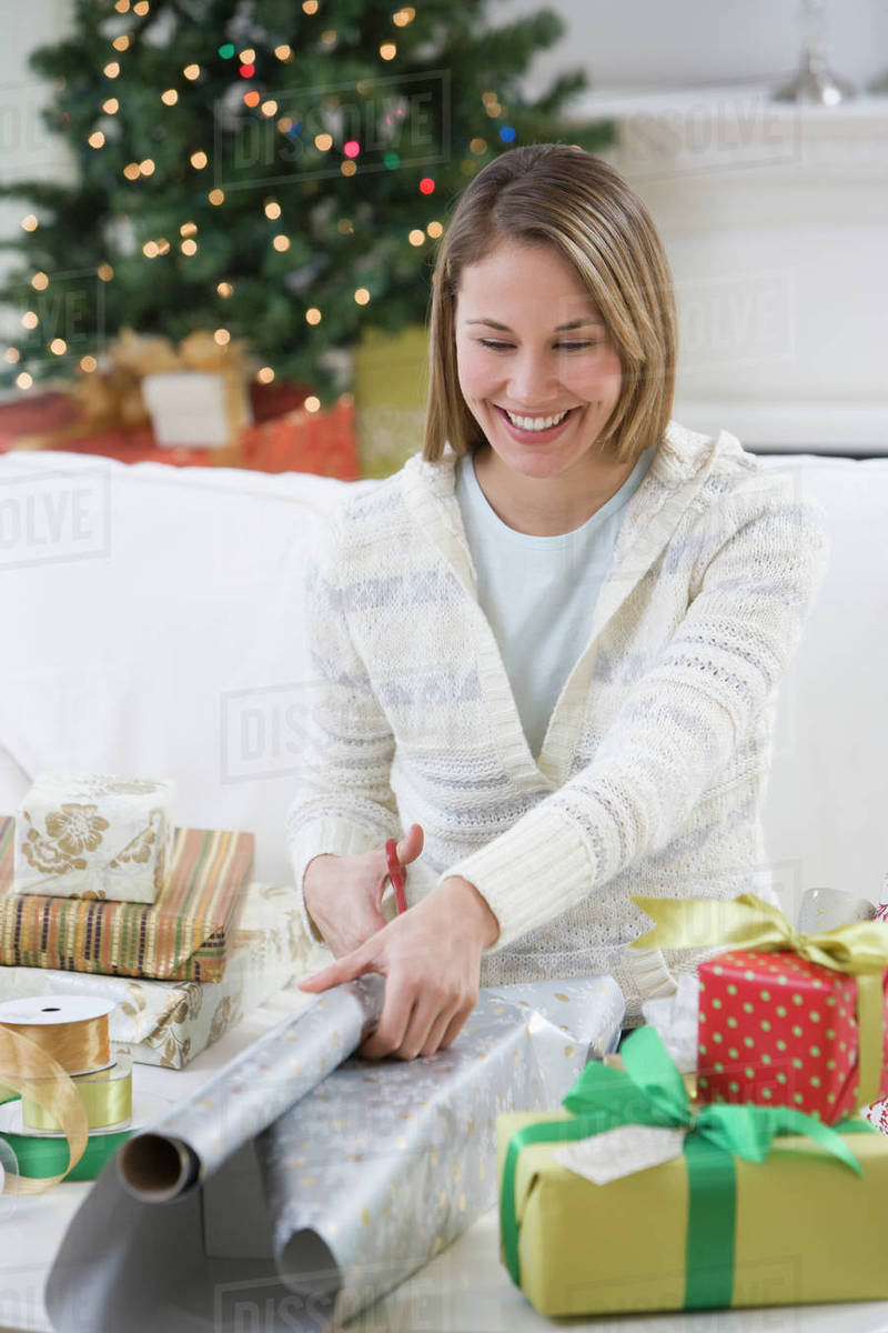 Woman wrapping Christmas gifts - Royalty-free Stock Photo | Dissolve