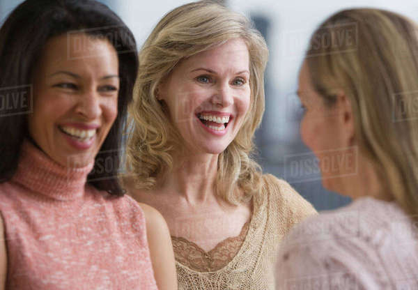 Multi-ethnic women laughing - Royalty-free Stock Photo | Dissolve