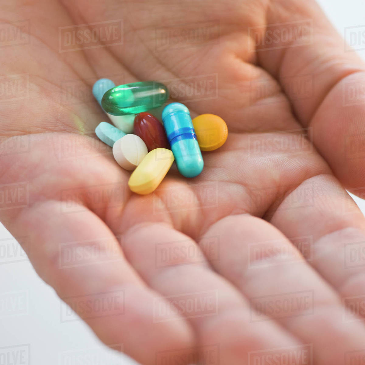 Close up of medication in man’s hand - Royalty-free Stock Photo | Dissolve
