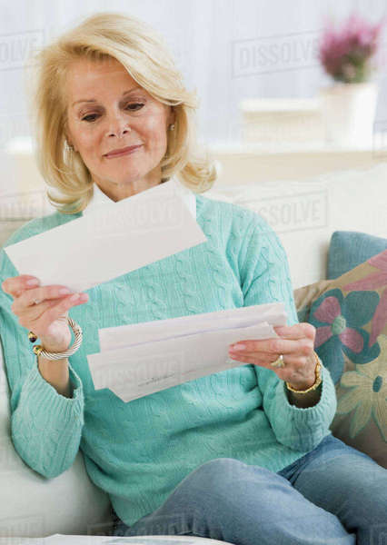 Senior woman reading mail - Royalty-free Stock Photo | Dissolve