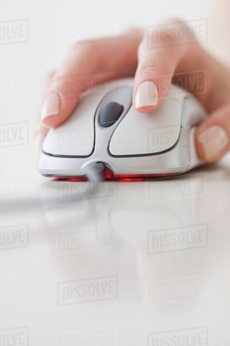 Woman’s hand on computer mouse - Royalty-free Stock Photo | Dissolve