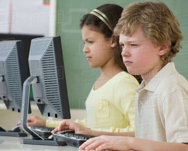 Multi-ethnic school children looking at computers - Royalty-free Stock ...