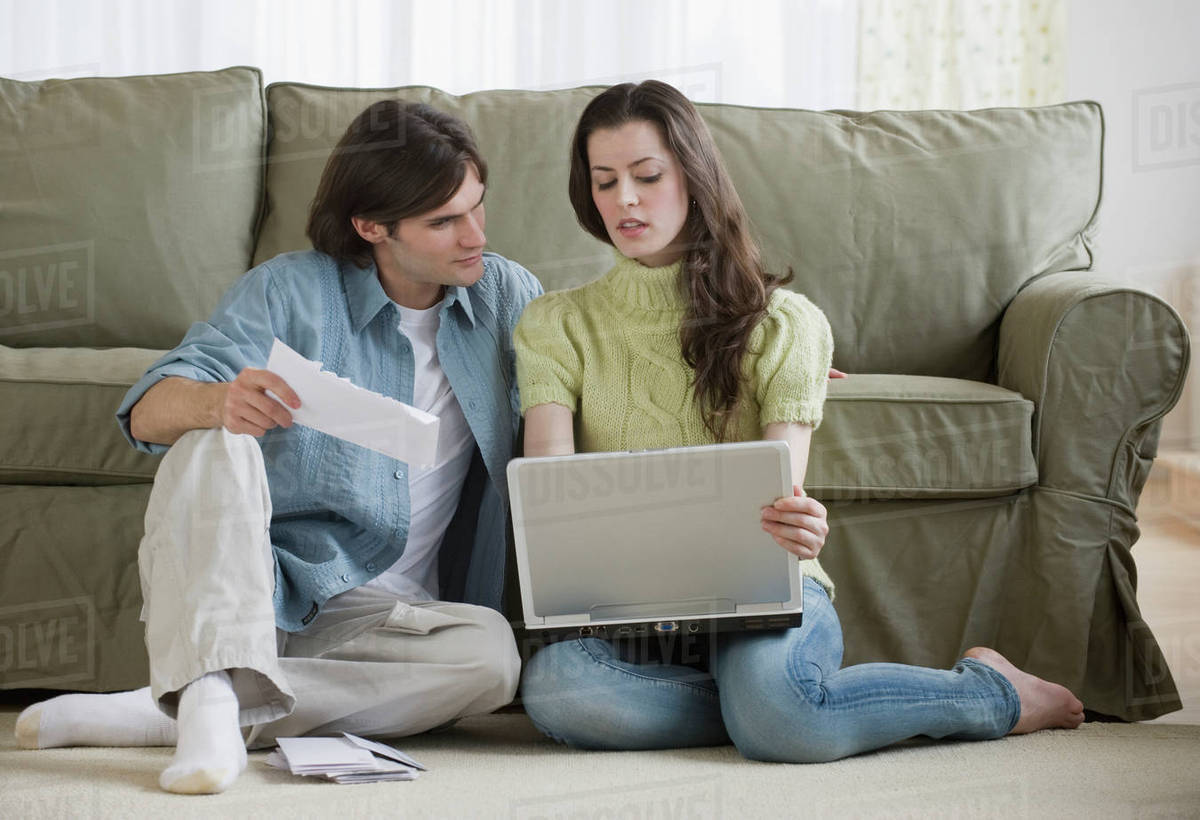 Couple looking at laptop - Royalty-free Stock Photo | Dissolve