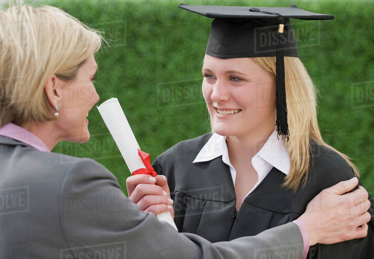 Mother congratulating graduate daughter - Stock Photo - Dissolve