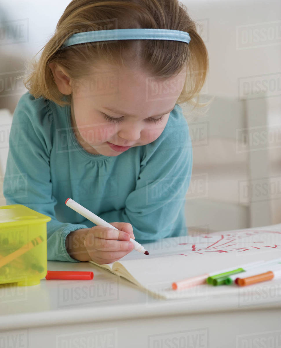 Close up of girl coloring - Royalty-free Stock Photo | Dissolve